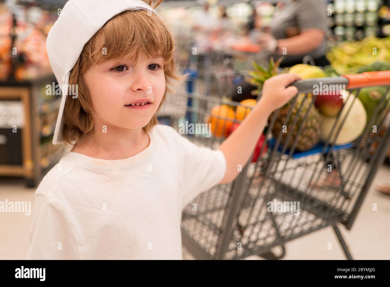 Sale, consumerism and people concept - happy little child with food in ...