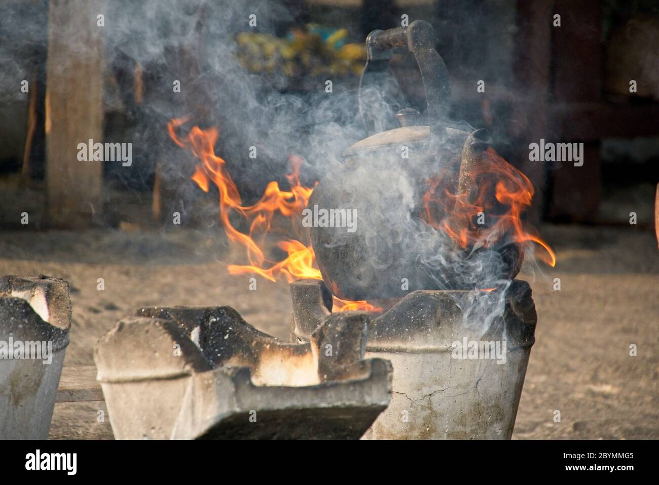 Ancient smoke-black kettle over flames on open wood fire Stock Photo ...