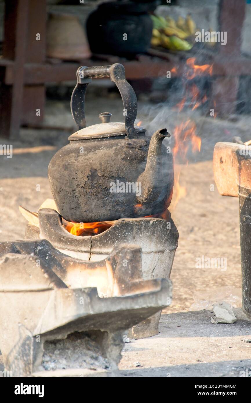 Ancient smoke-black kettle over flames on open wood fire Stock Photo ...