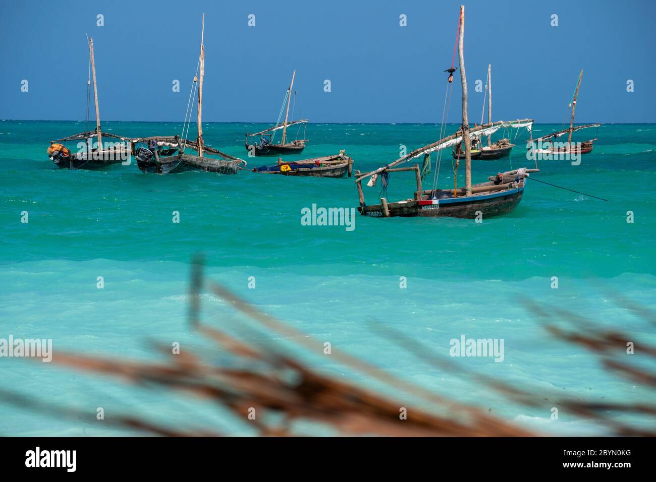 Anchored Traditional wooden dhow boats on the amazing turquoise water ...