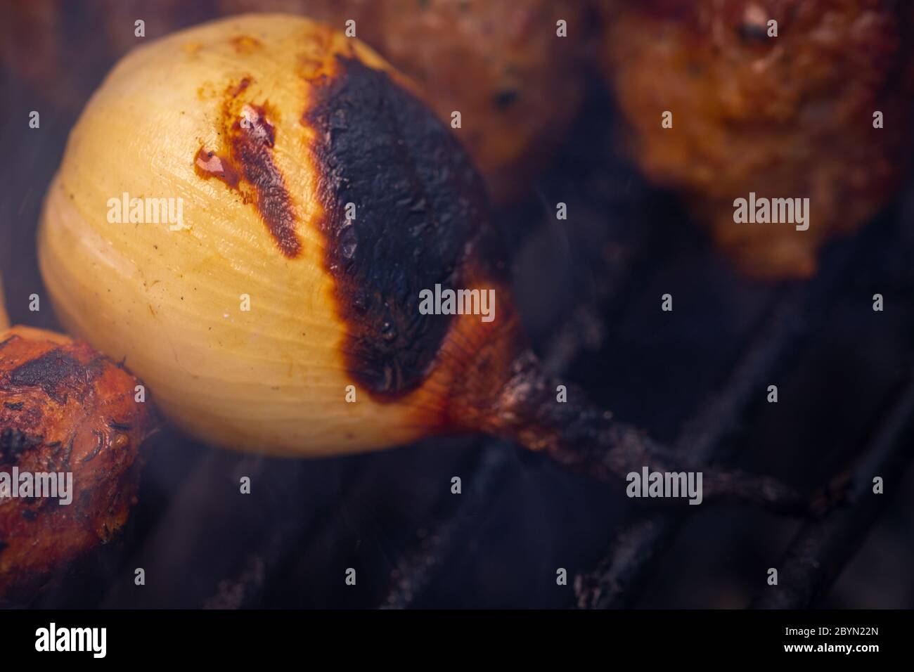 Grilled onion on a charcoal barbeque. Onion on BBQ Stock Photo - Alamy