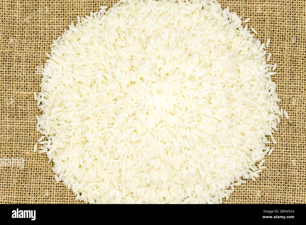 thai raw rice on sack isolated white background Stock Photo - Alamy