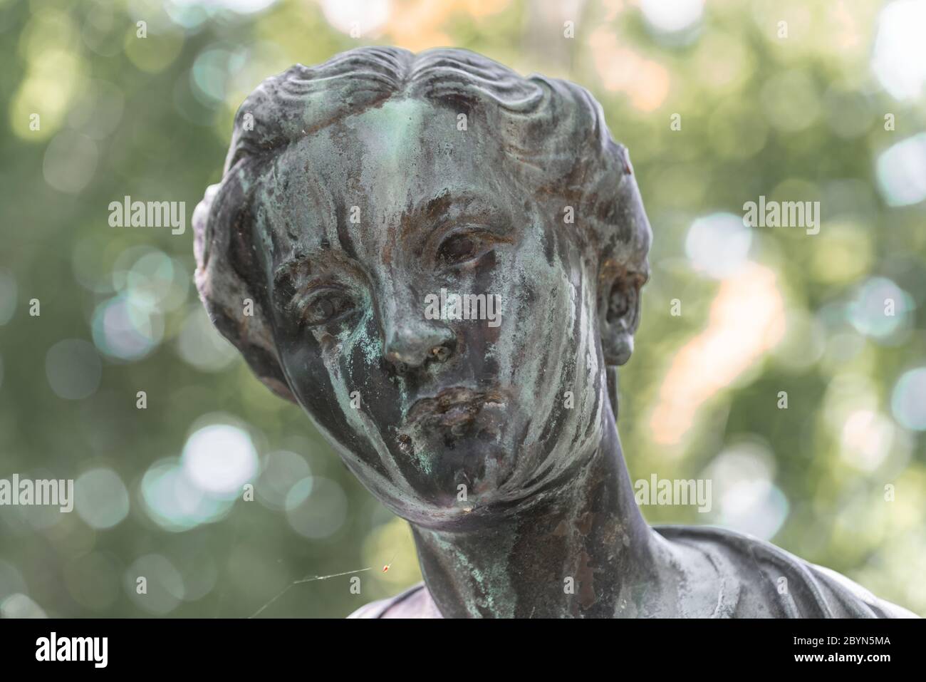 Close up of a female bronze statue of a woman with short hair with ...
