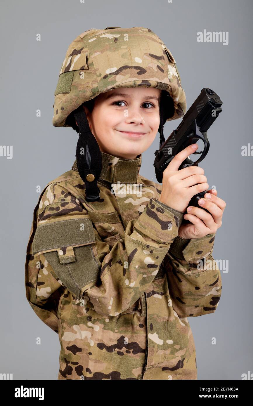 Young boy dressed like a soldier with a gun Stock Photo - Alamy