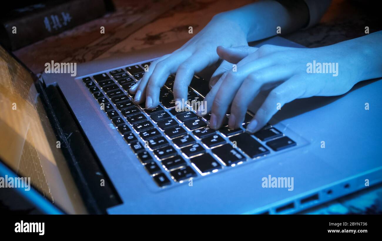 Closeup image of girls hands typing on laptop keyboard at night Stock ...