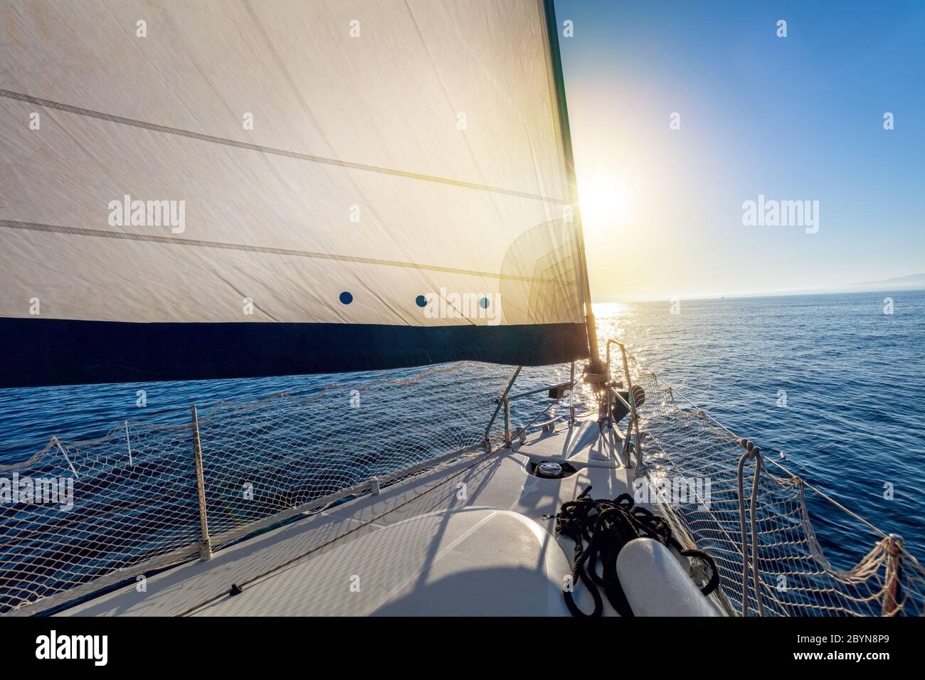 Sailing at calm weather with sun. A view from the yacht's deck to the ...