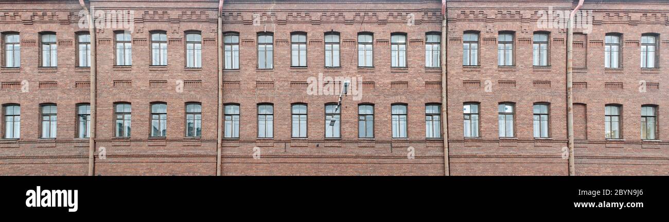Panorama of the facade of an old brick apartment building as a ...
