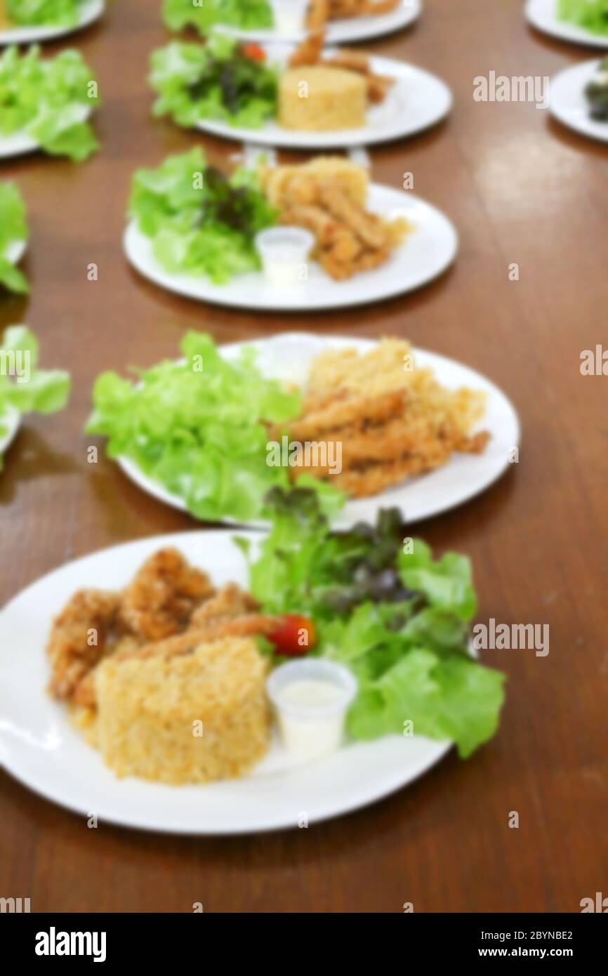 blurred of food, fried rice and breaded fried chicken in white plate ...