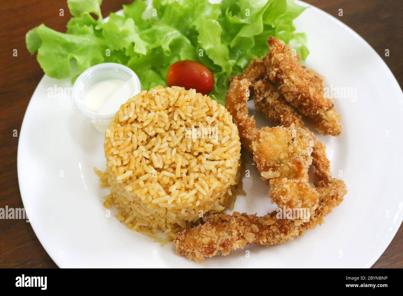 fried rice and breaded fried chicken in white plate Stock Photo - Alamy