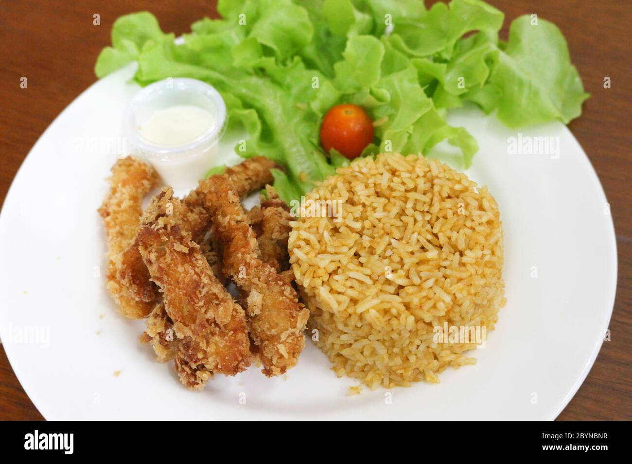 fried rice and breaded fried chicken in white plate Stock Photo - Alamy