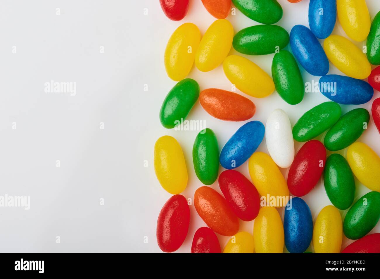 Oval colorful candy with copy space on white background Stock Photo - Alamy