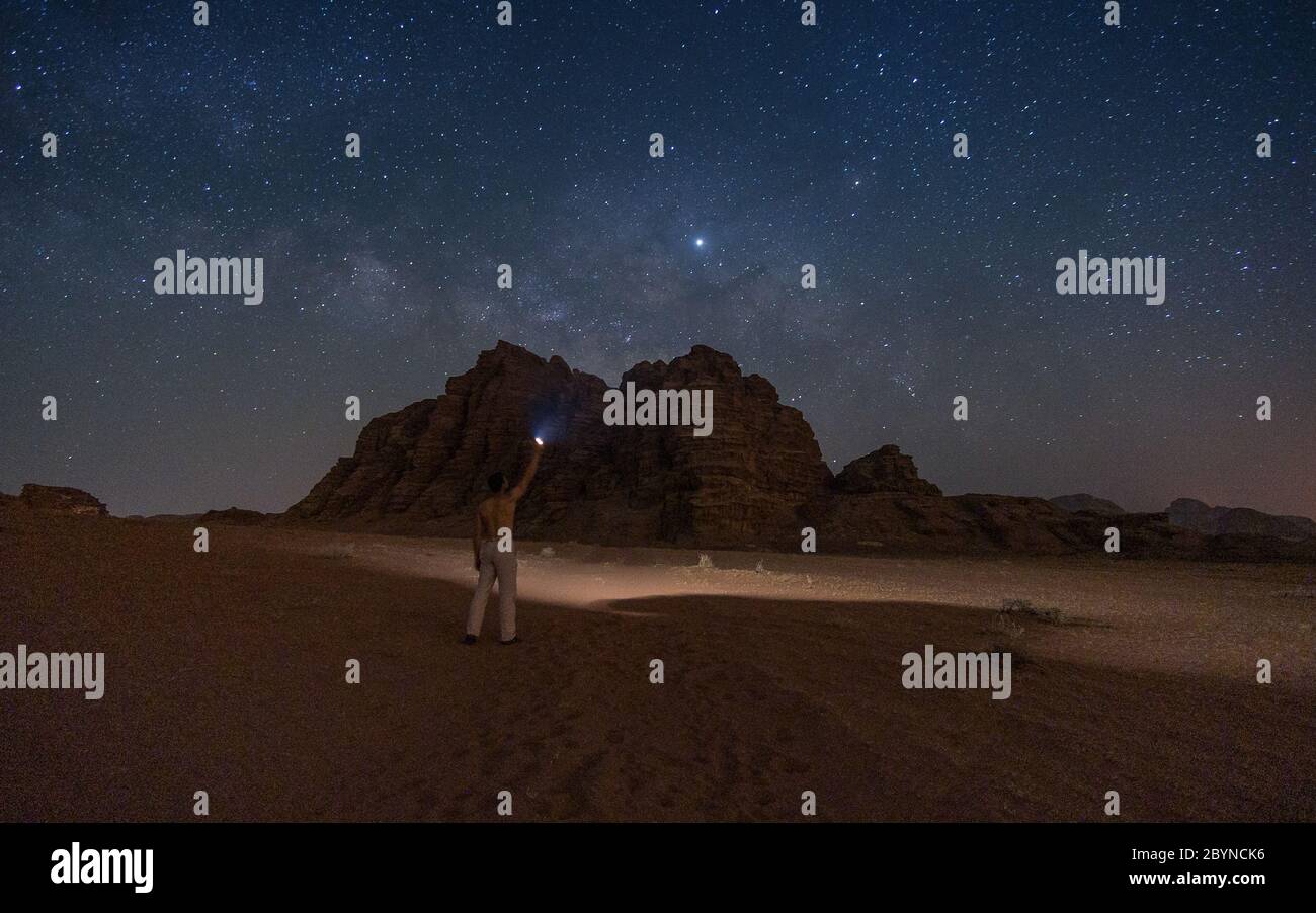 Man lighting up the White Domes in Wadi-Rum desert, Jordan, Middle East ...