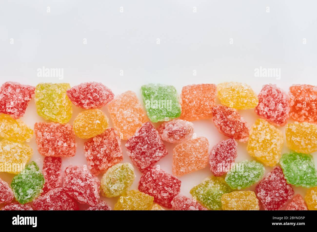 Sweet sugar candy background with white studio backdrop Stock Photo - Alamy