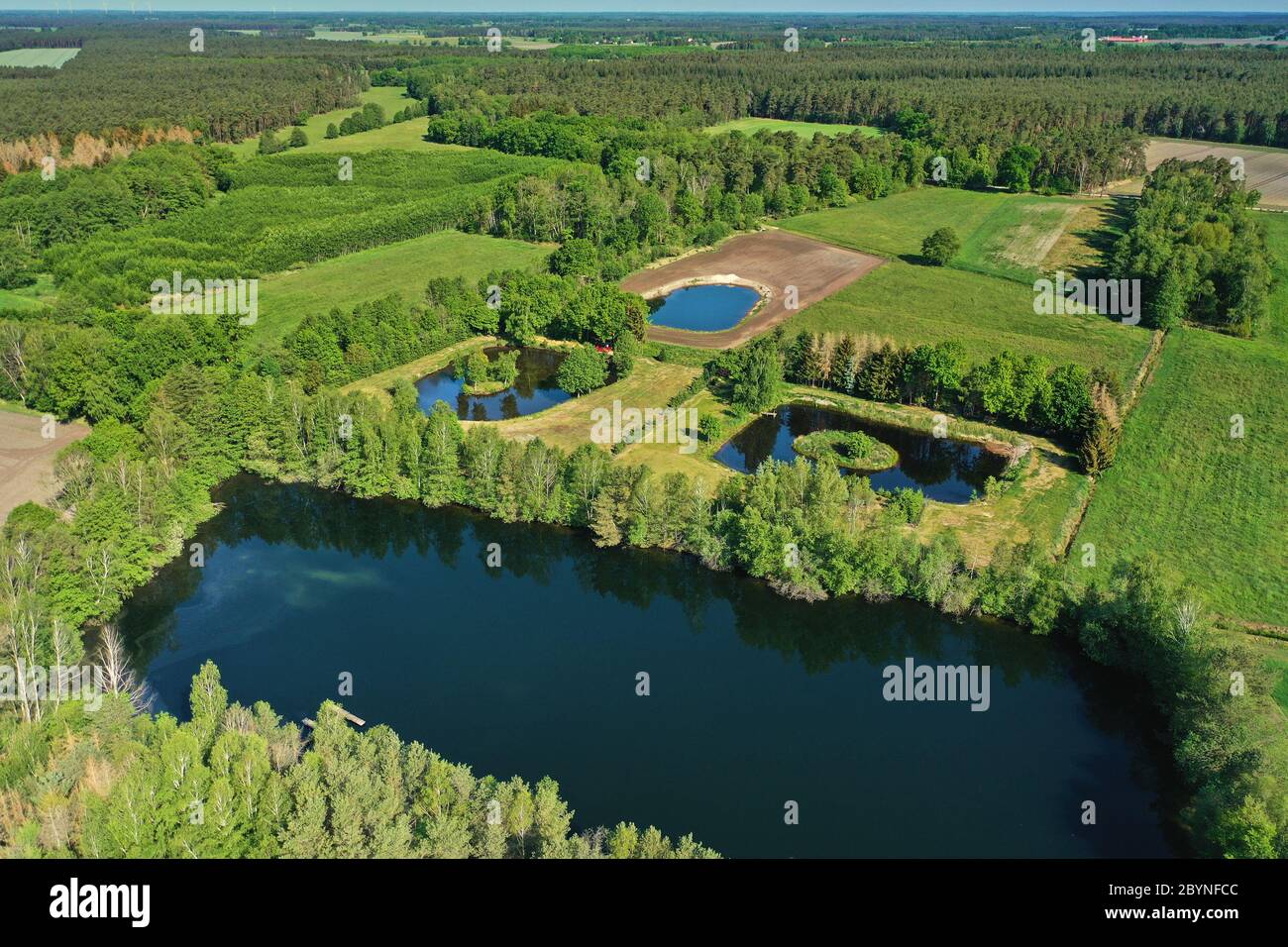 Aerial view of a large rectangular pond in front of smaller ponds in a ...