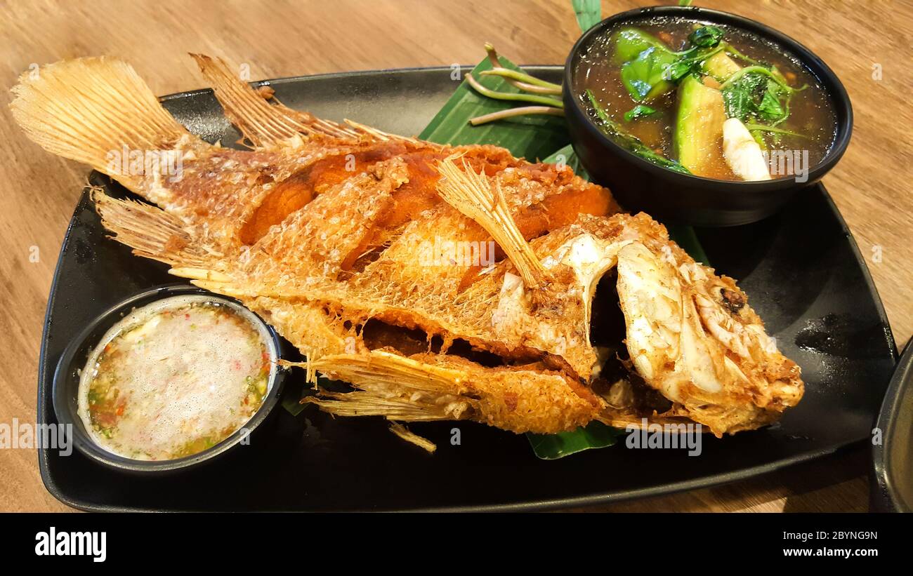 fried river fish on black dish Stock Photo - Alamy