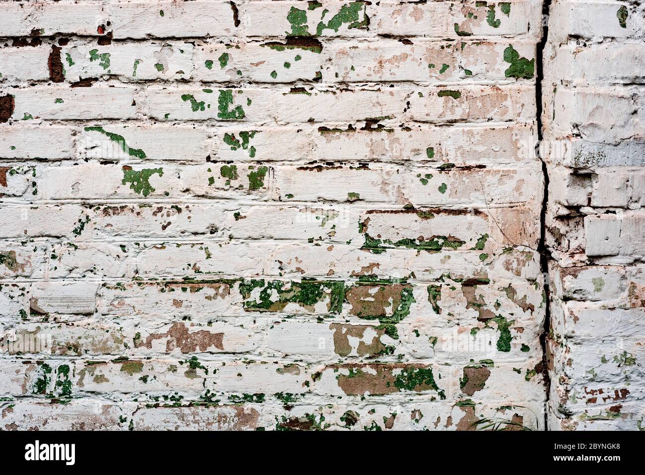 Weathered texture of stained old green and white brick wall background ...