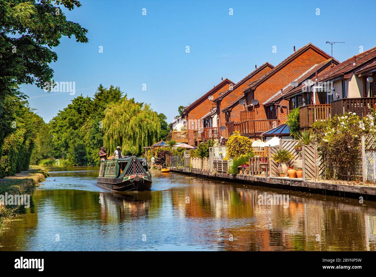 Canal narrowboat passing through the Cheshire village of Waverton near ...