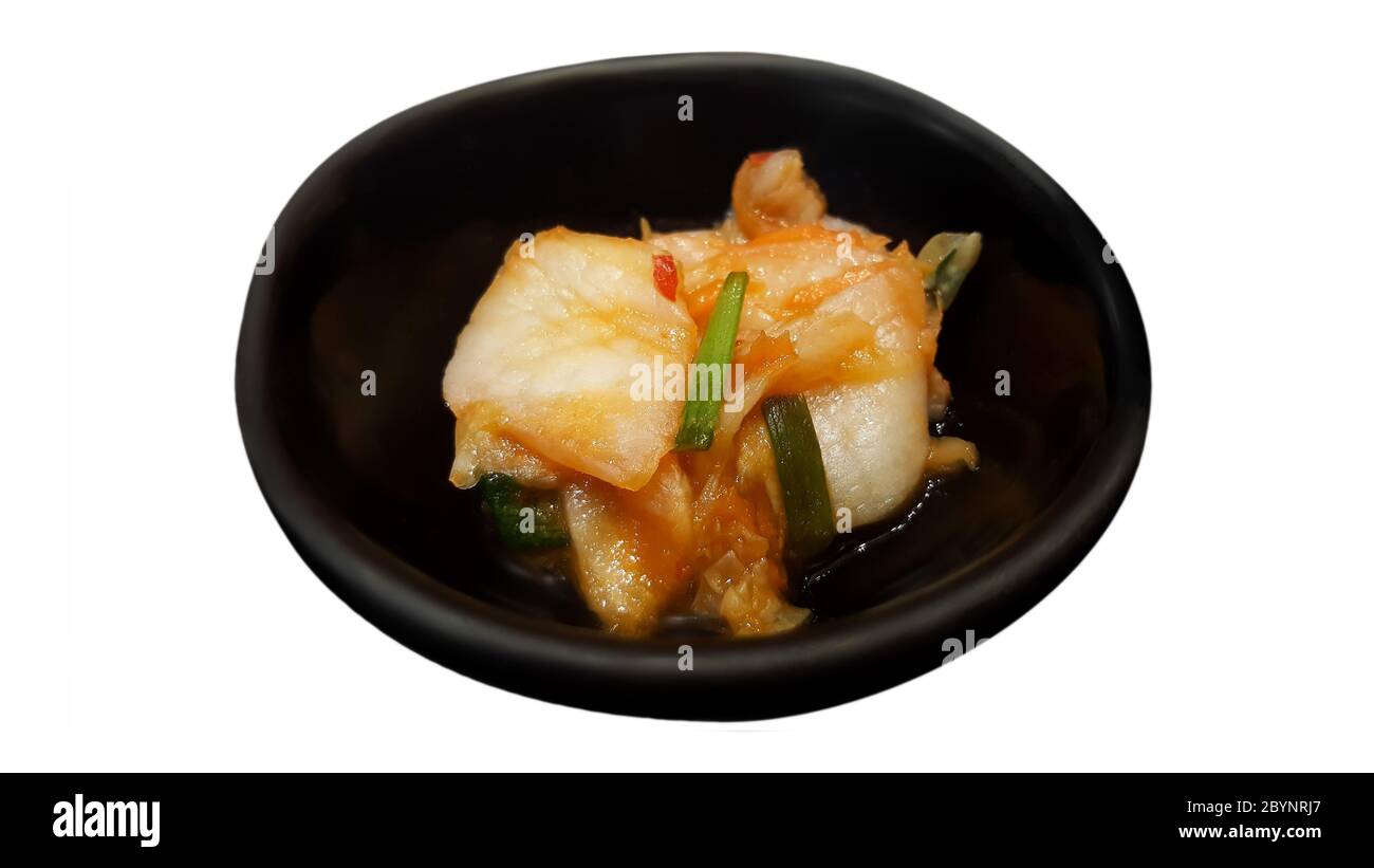 kimchi in black plate isolated on background with clipping path Stock ...