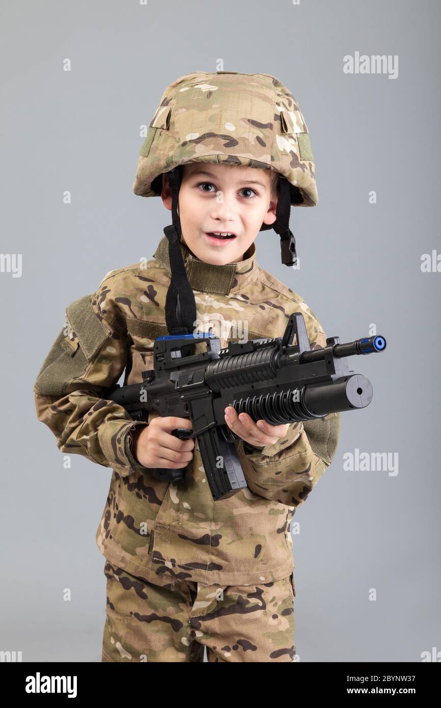 Young boy dressed like a soldier with rifle Stock Photo - Alamy