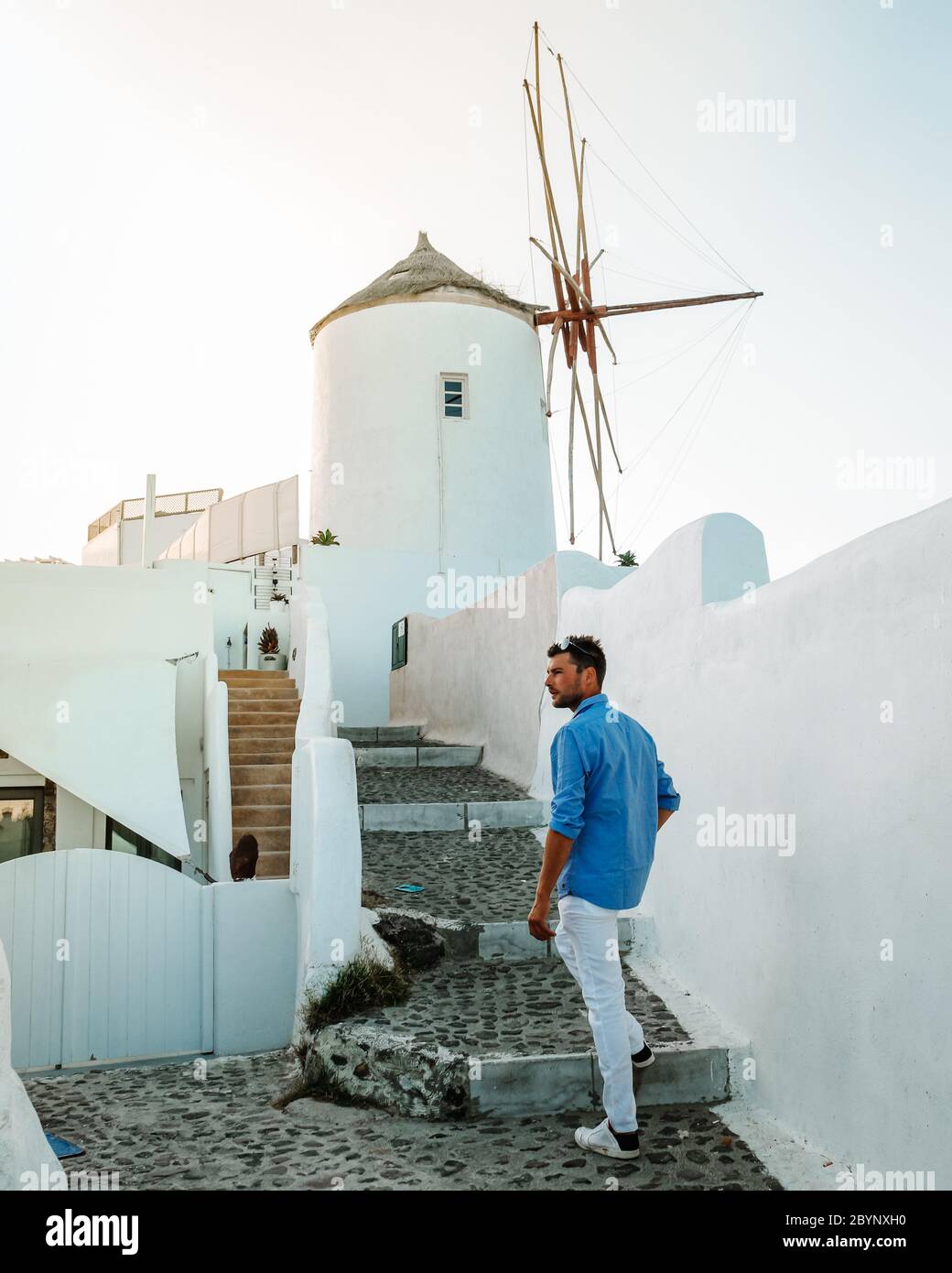 Santorini Greece, young men on vacation at the Island of Greece ...
