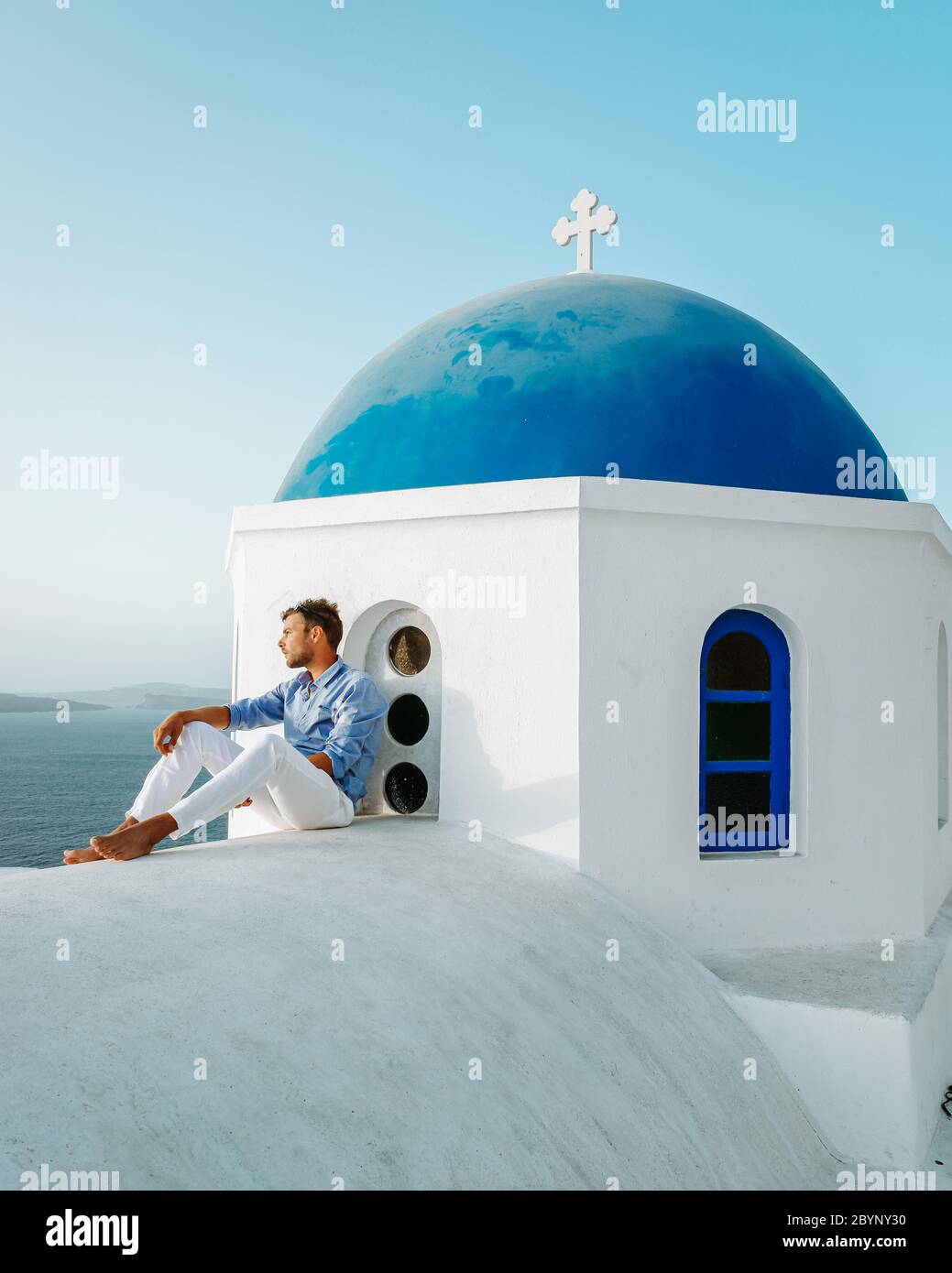 Santorini Greece, young men on vacation at the Island of Greece ...