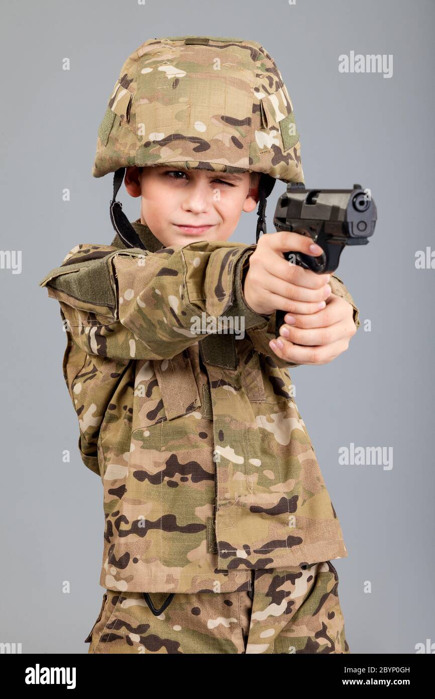 Young boy dressed like a soldier with a gun Stock Photo - Alamy
