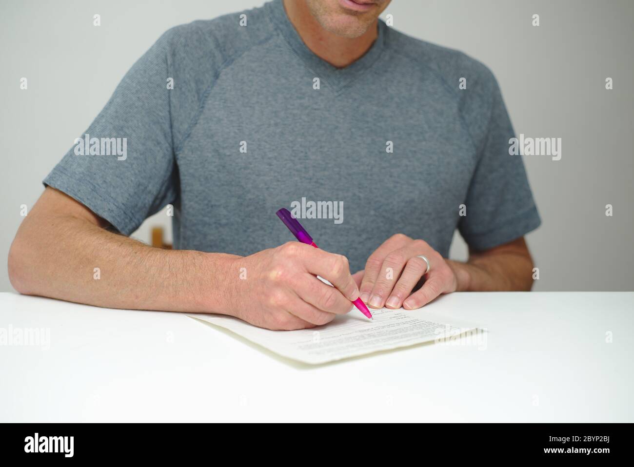 Signing name to paper document Stock Photo - Alamy
