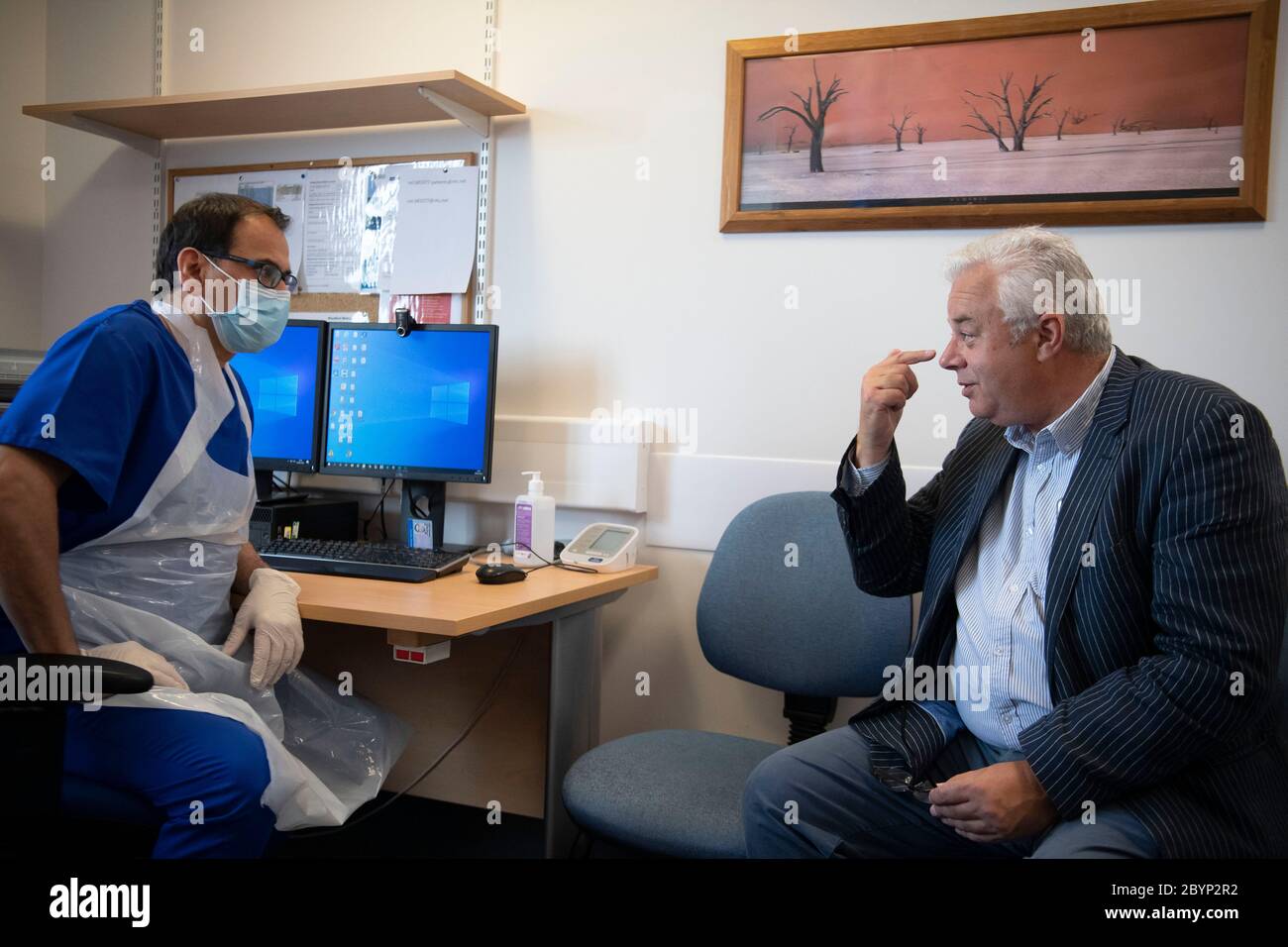 Doctor Khurram Jafri (left) wears personal protective equipment (PPE ...