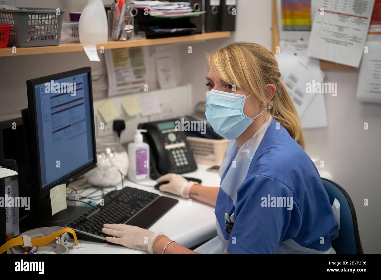Healthcare assistant wearing personal protective equipment ppe speaks ...