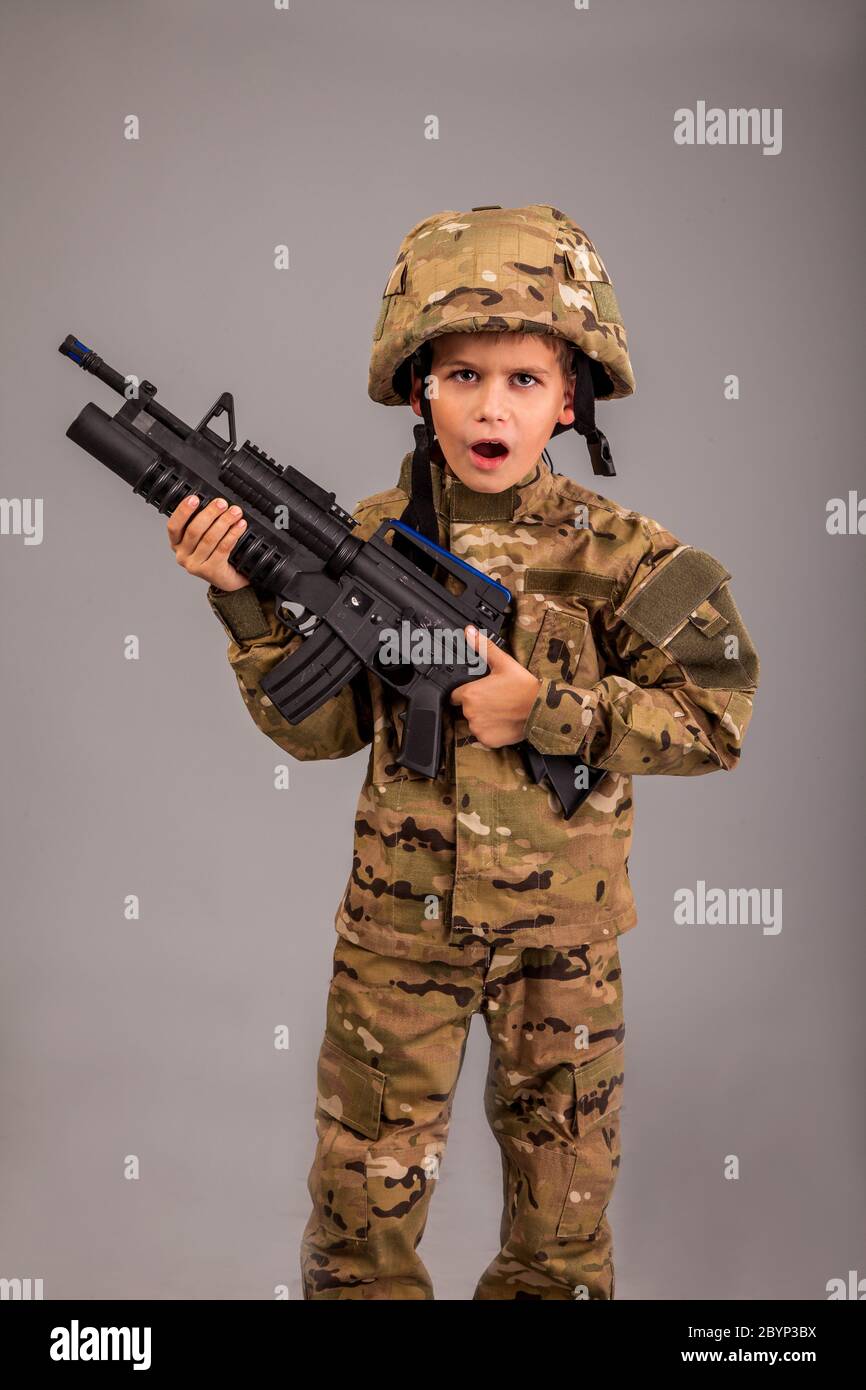 Young boy dressed like a soldier with rifle Stock Photo - Alamy