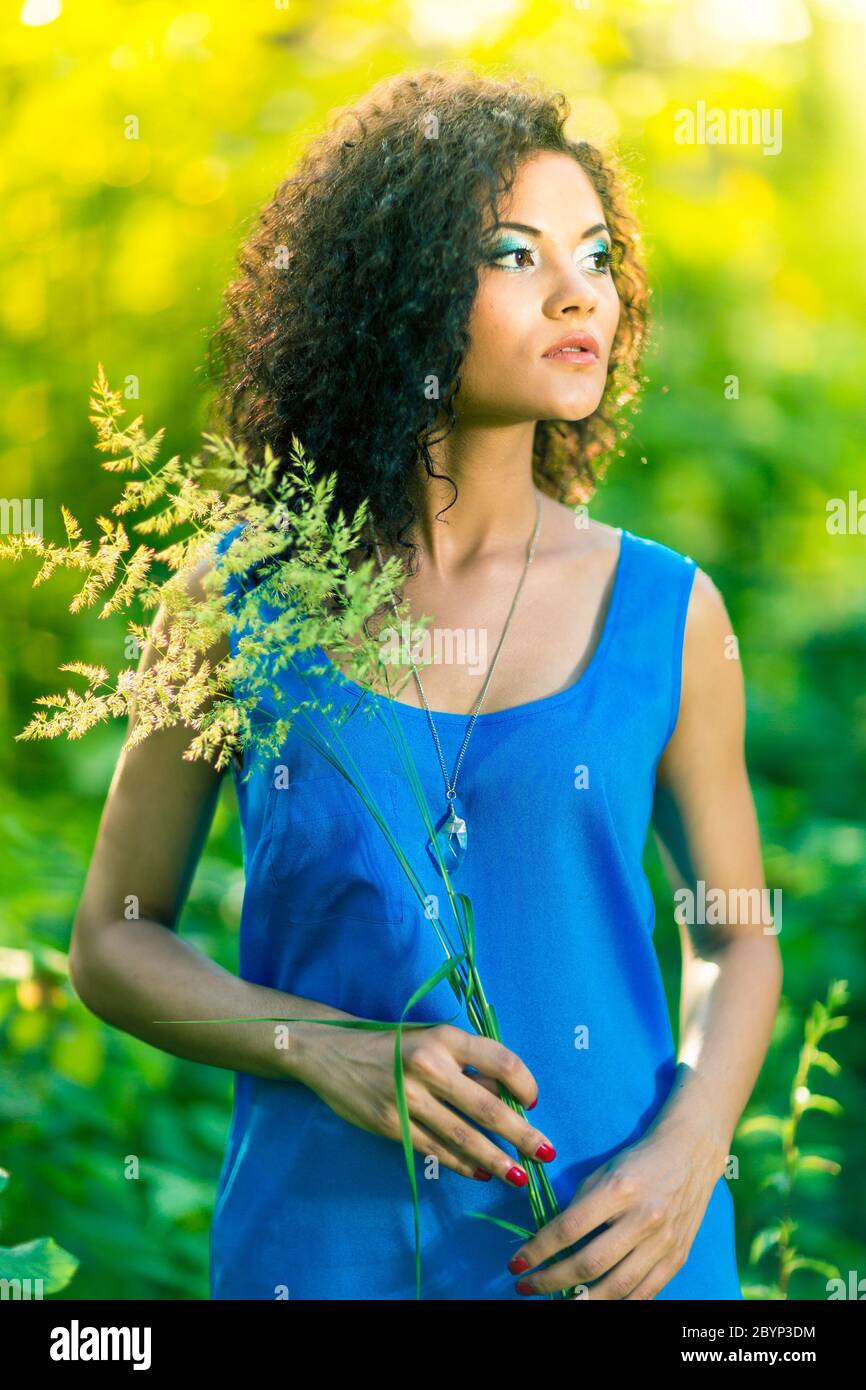 Young relaxing female lying on her stomach in the grass Stock Photo - Alamy