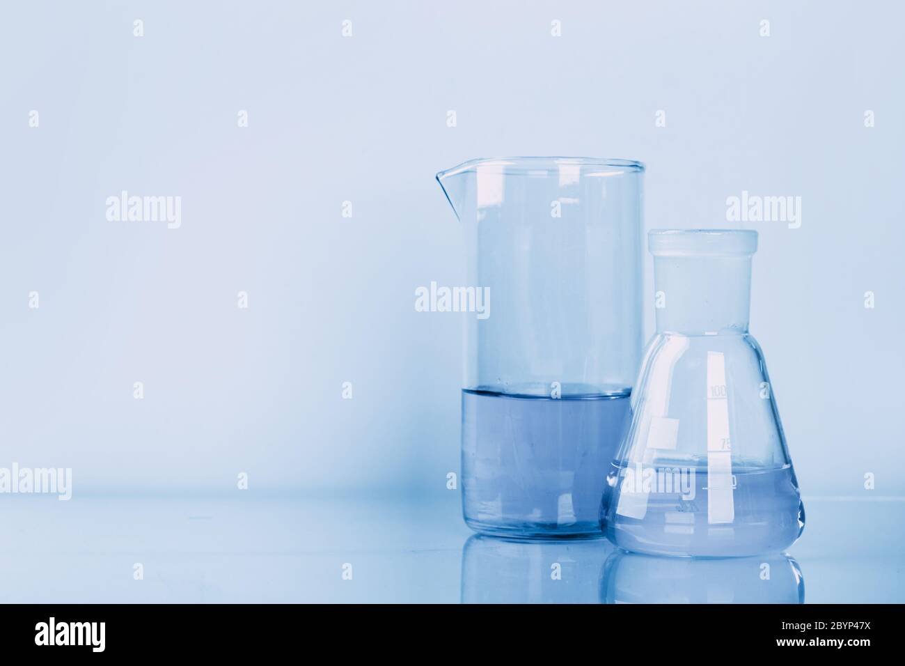 Laboratory glassware with a pipette and test tubes. scientific ...