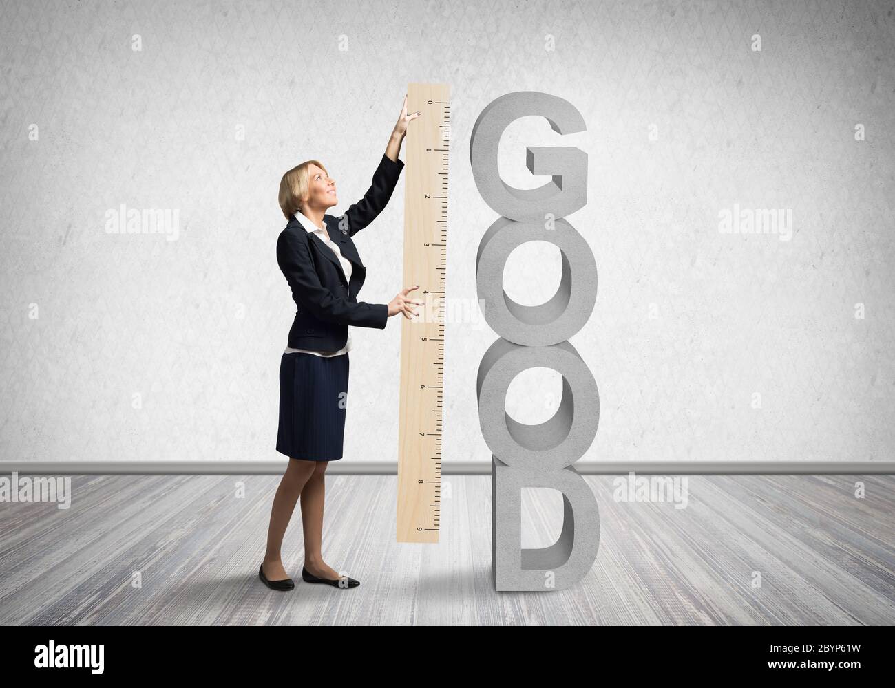 Woman in business suit holding big ruler Stock Photo - Alamy