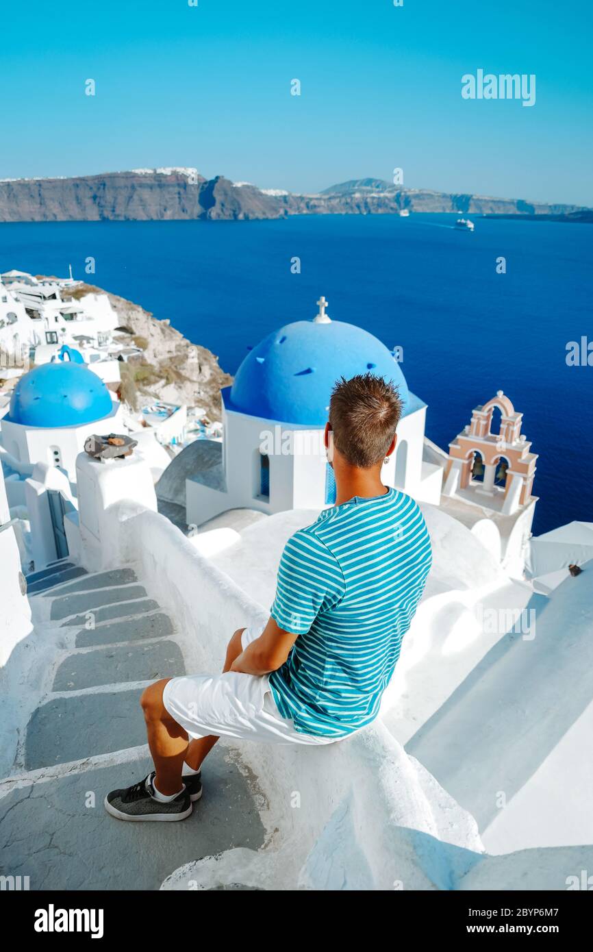 Santorini Greece, young men on vacation at the Island of Greece ...
