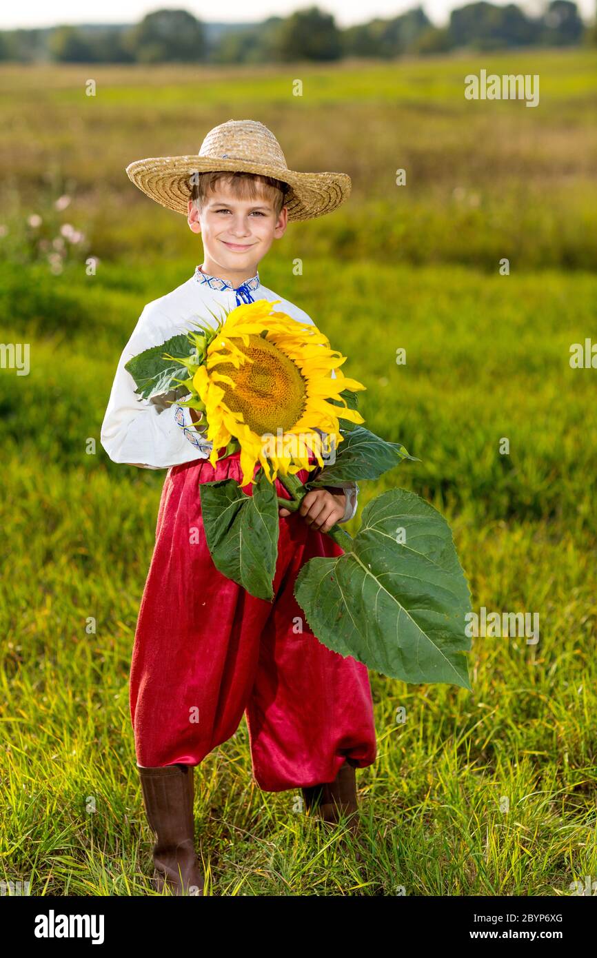Boy with sunflower hi-res stock photography and images - Alamy