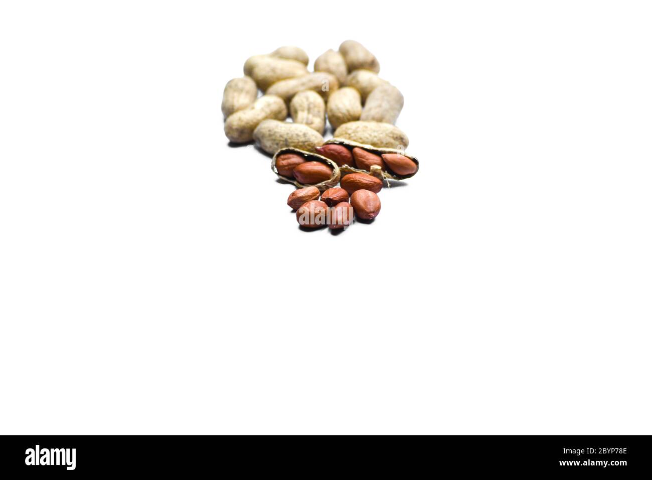 Close up view of shelled peanuts and cracked peanuts isolated on white ...