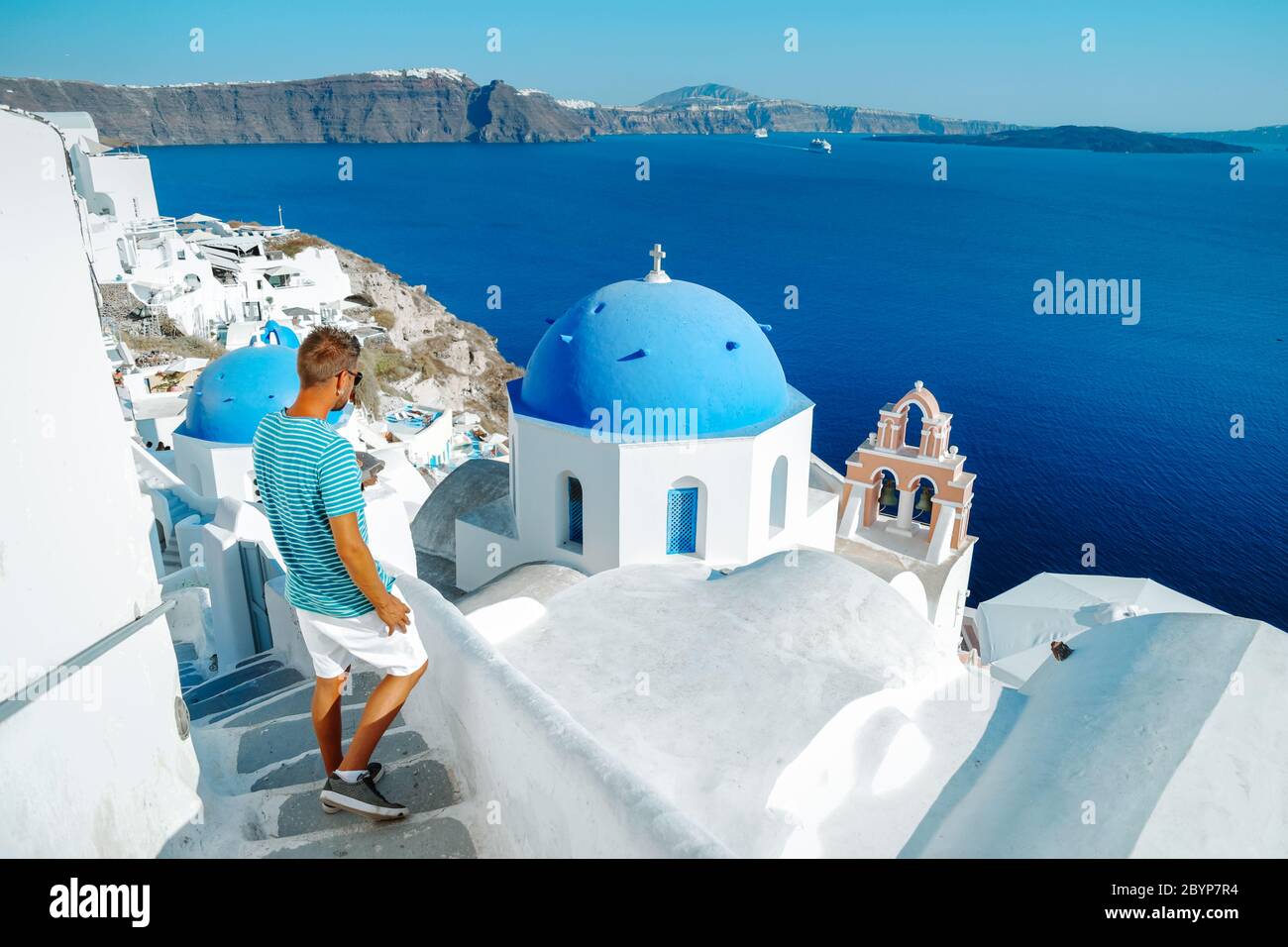 Santorini Greece, young men on vacation at the Island of Greece ...