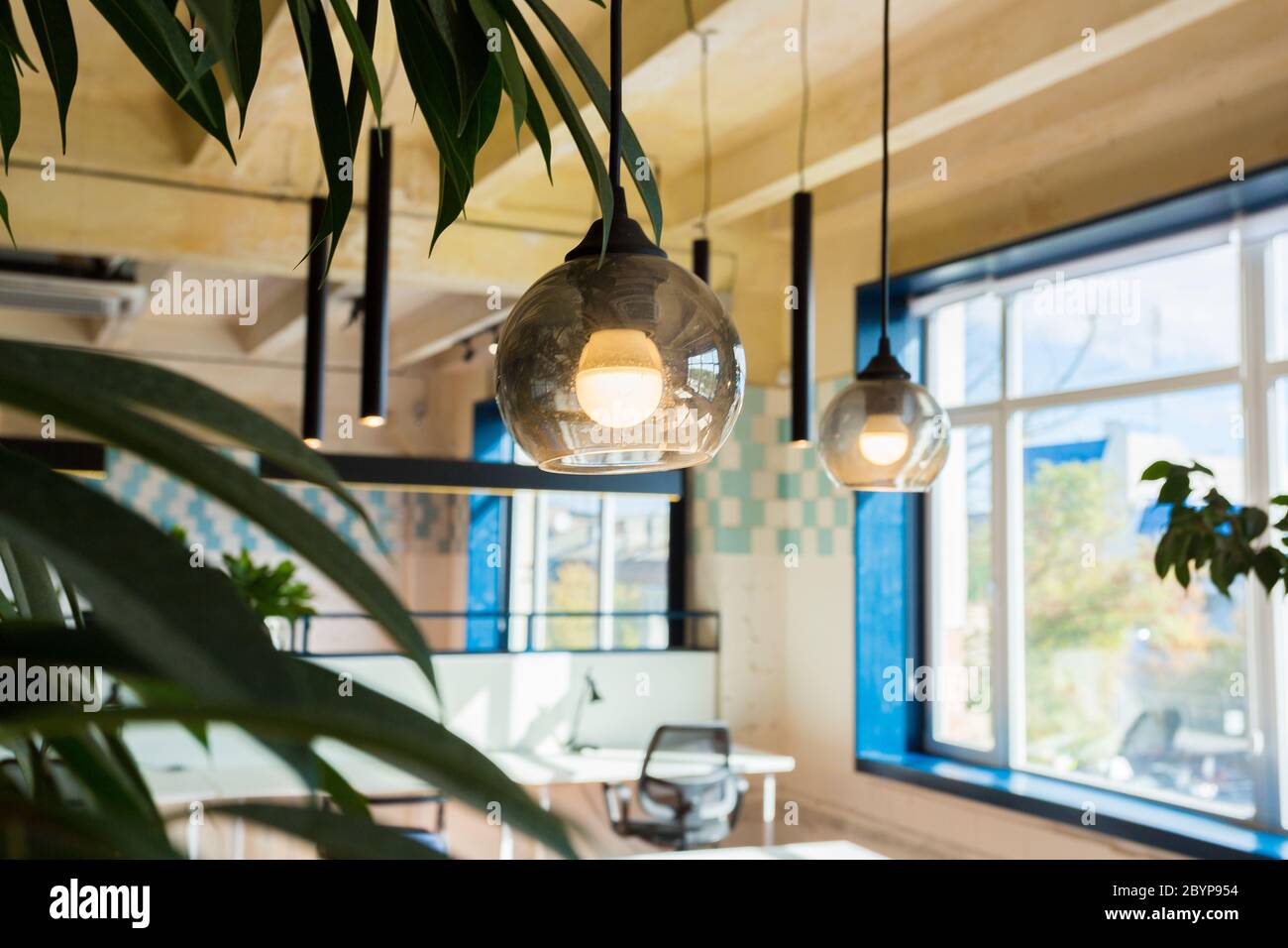 modern glass and metal loft lamps in a design office Stock Photo - Alamy