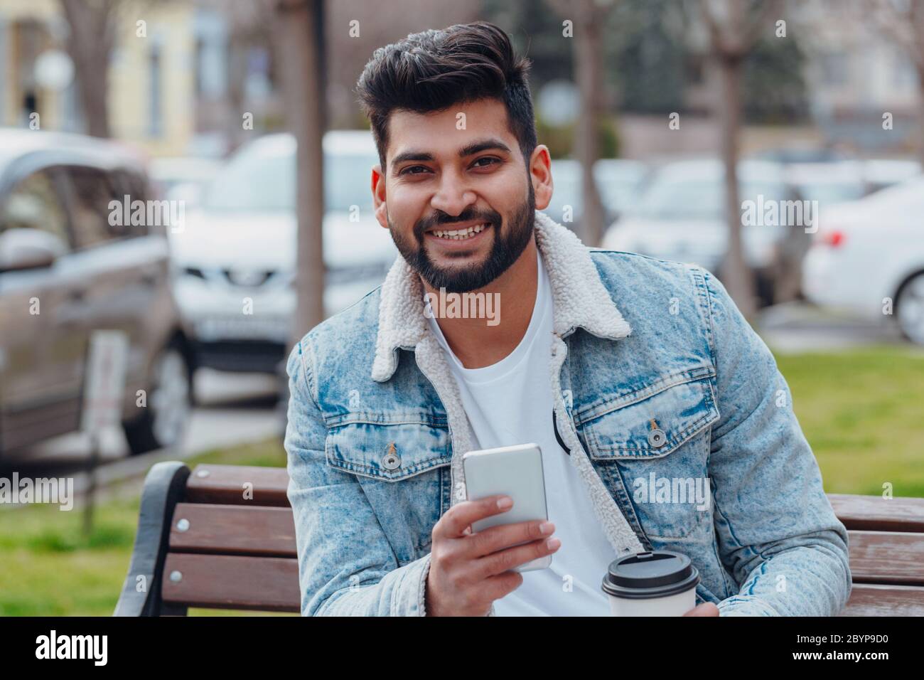 Bearded Indian man on the street using the application in his smartphone Stock Photo - Alamy