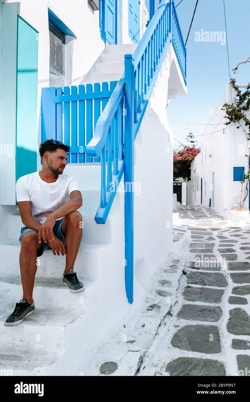 young guy on vacation at the Greek Island of Mykonos, men relaxing at ...