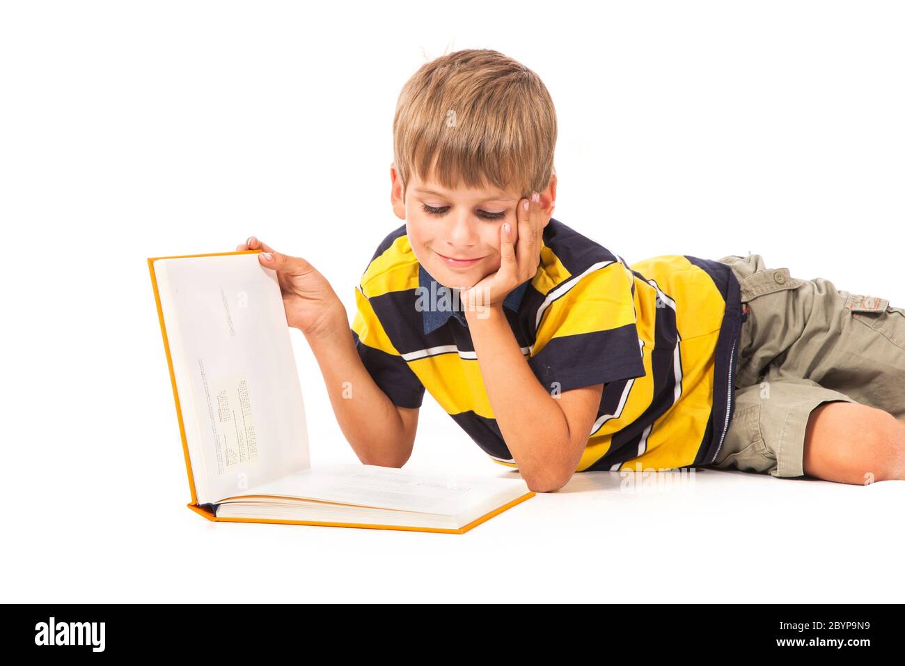 School boy is holding a book Stock Photo - Alamy