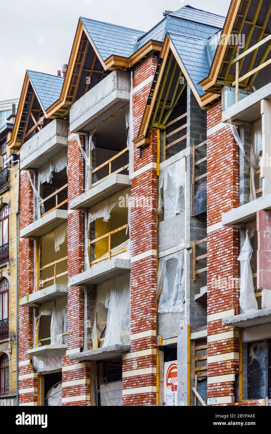 Torn plastic sheeting across window openings on building site showing ...