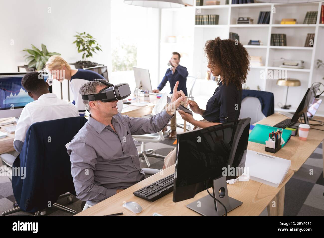 Multi races group working together Stock Photo - Alamy