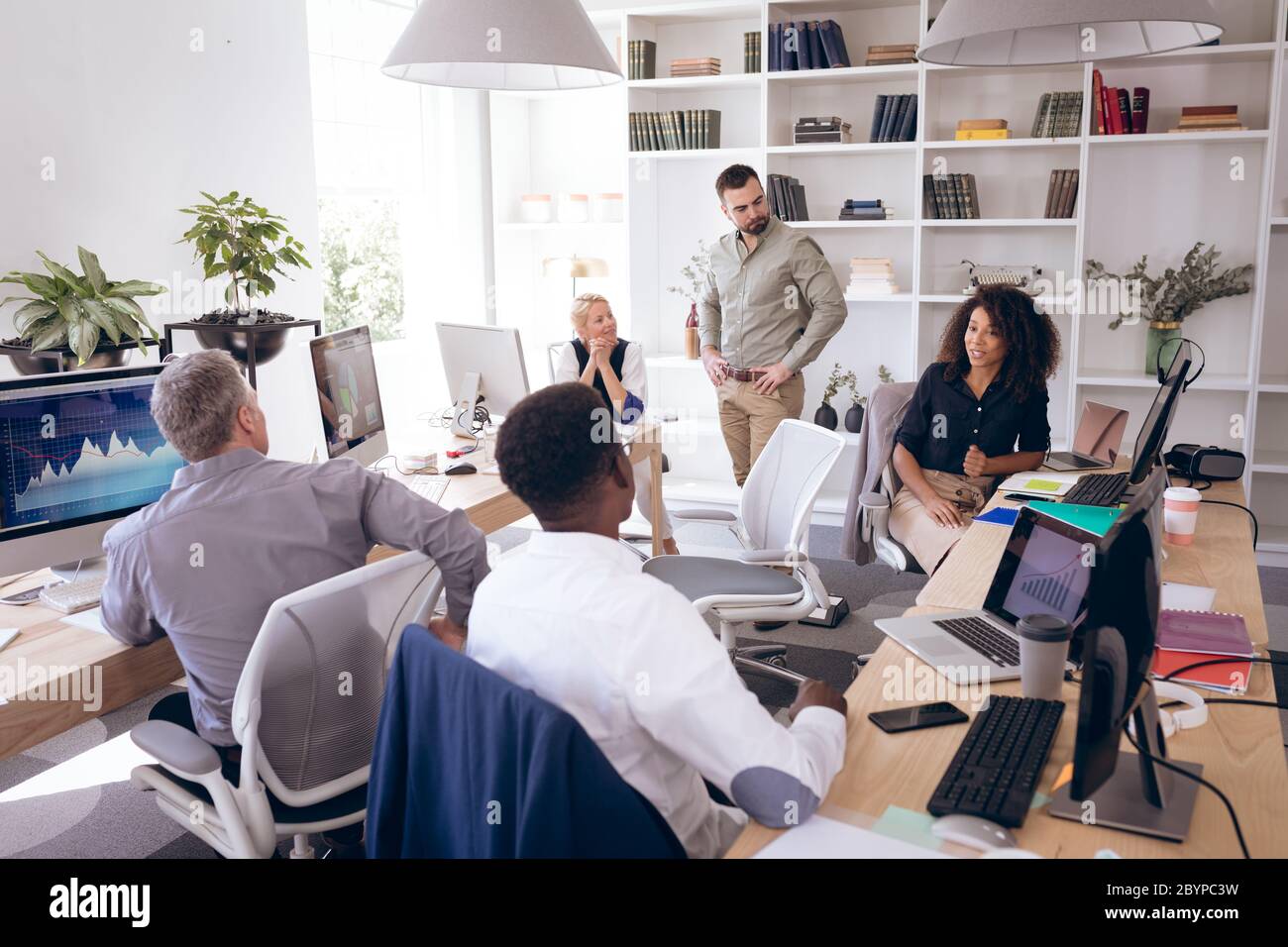 Happy multi races businesspeople working together Stock Photo - Alamy