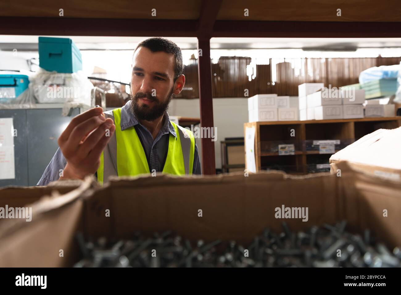 Worker inspecting a wheelchairs part Stock Photo - Alamy