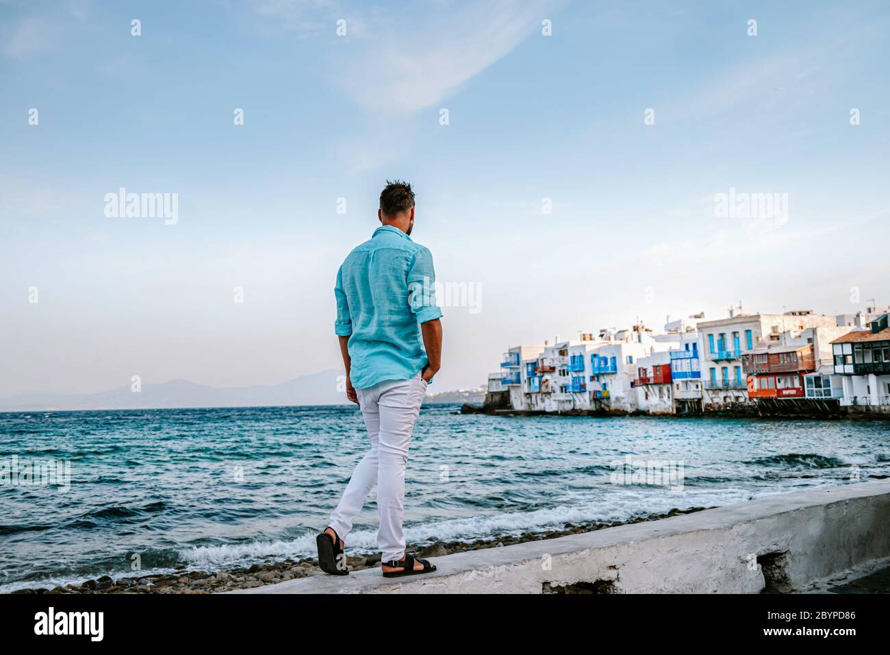 young guy on vacation at the Greek Island of Mykonos, men relaxing at ...