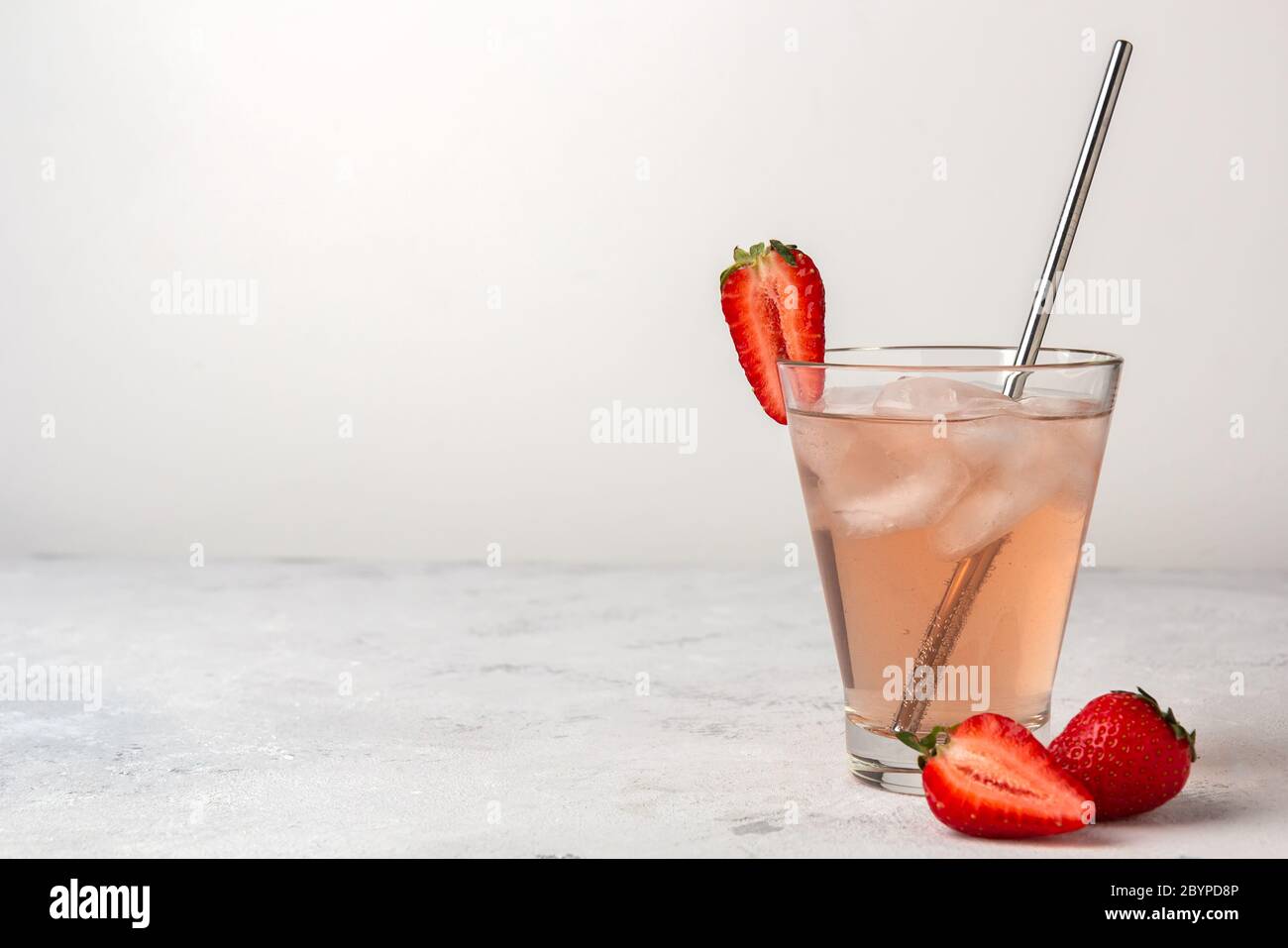 Strawberry lemonade with ice on a light background. Copy space Stock ...