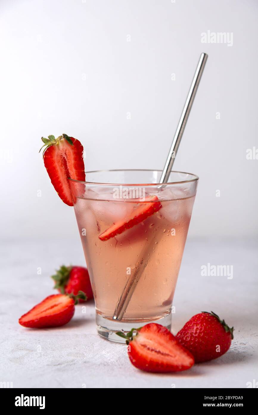 Cold strawberry fizzy tea on a white background Stock Photo - Alamy