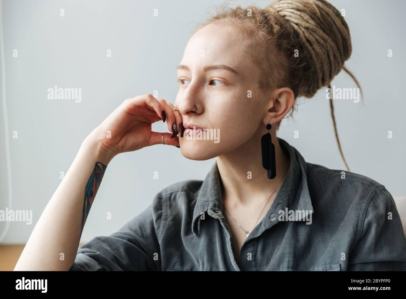 Image of a relaxing thinking amazing young girl with dreadlocks posing ...