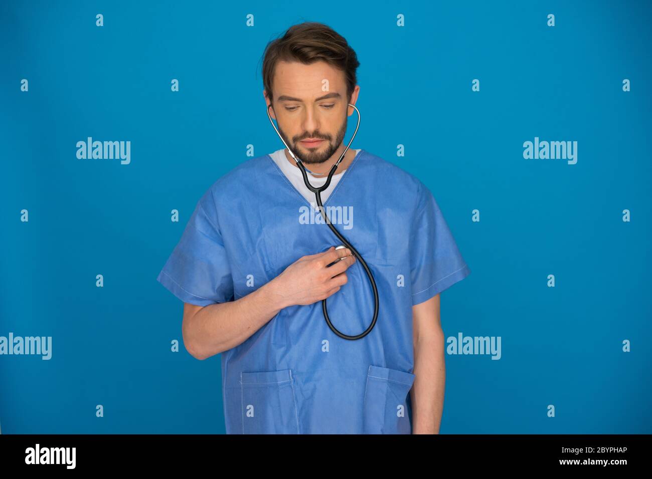 Doctor holding a stethoscope staring at the floor Stock Photo - Alamy